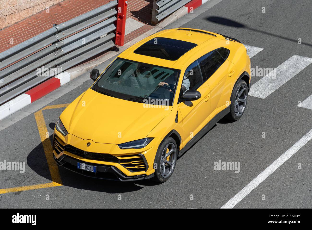 Yellow Lamborghini Urus driving on the road Stock Photo - Alamy