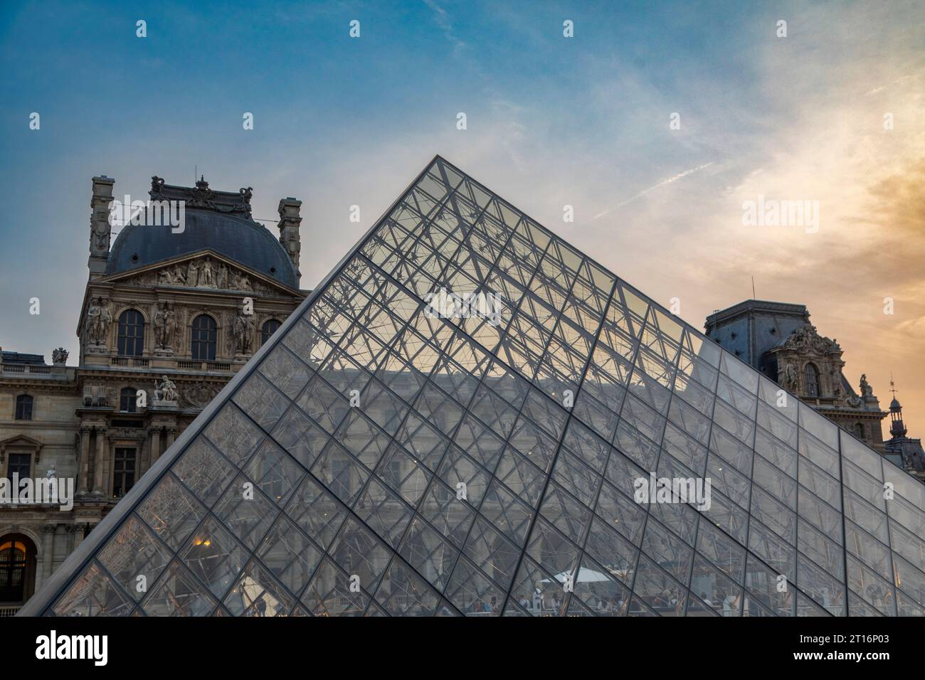 Courtyard and glass pyramid of the Louvre Museum at dusk, Paris, France ...
