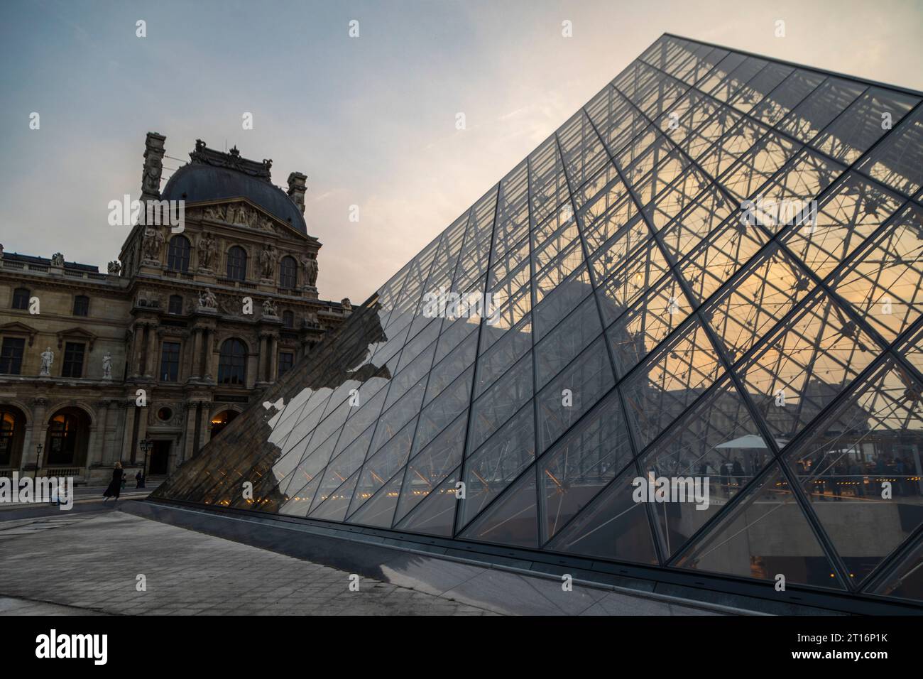 Courtyard and glass pyramid of the Louvre Museum at dusk, Paris, France ...
