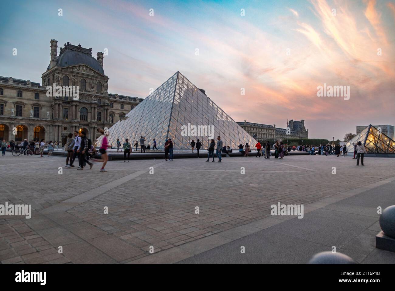 Courtyard and glass pyramid of the Louvre Museum at dusk, Paris, France ...
