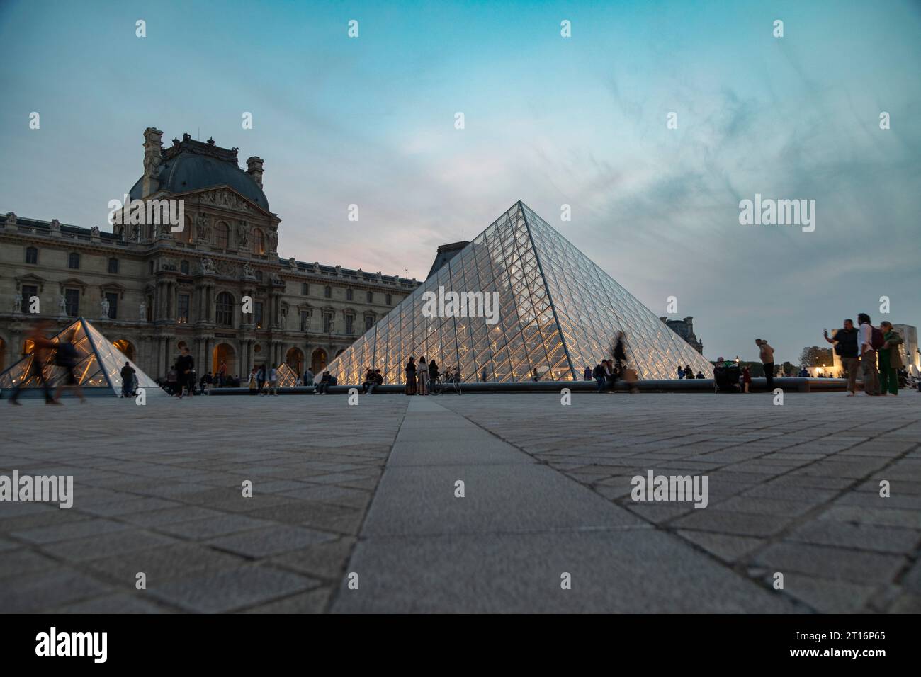 Courtyard and glass pyramid of the Louvre Museum at dusk, Paris, France ...