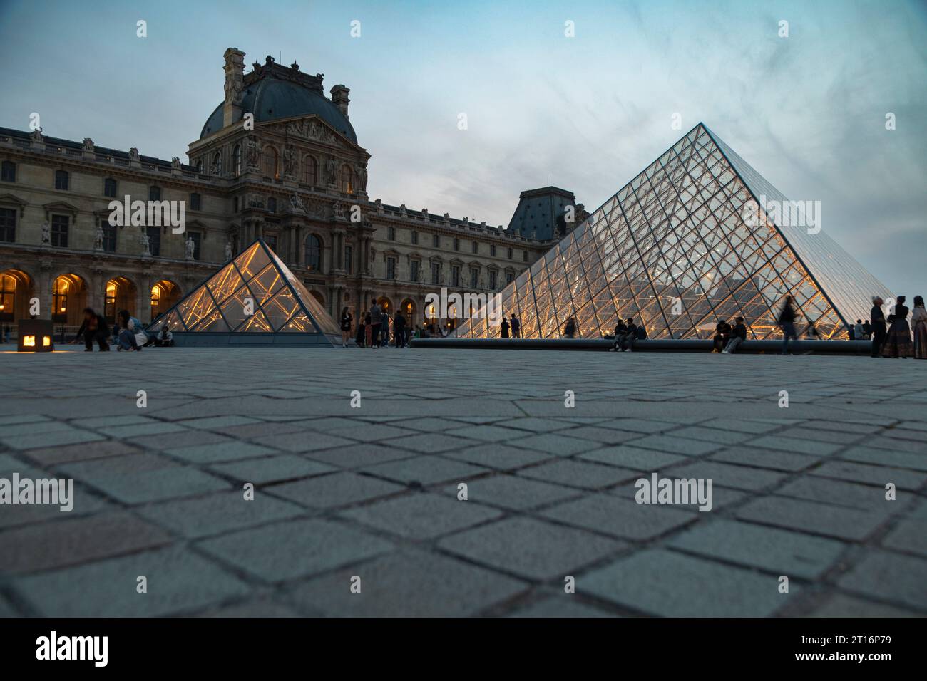 Courtyard and glass pyramid of the Louvre Museum at dusk, Paris, France ...