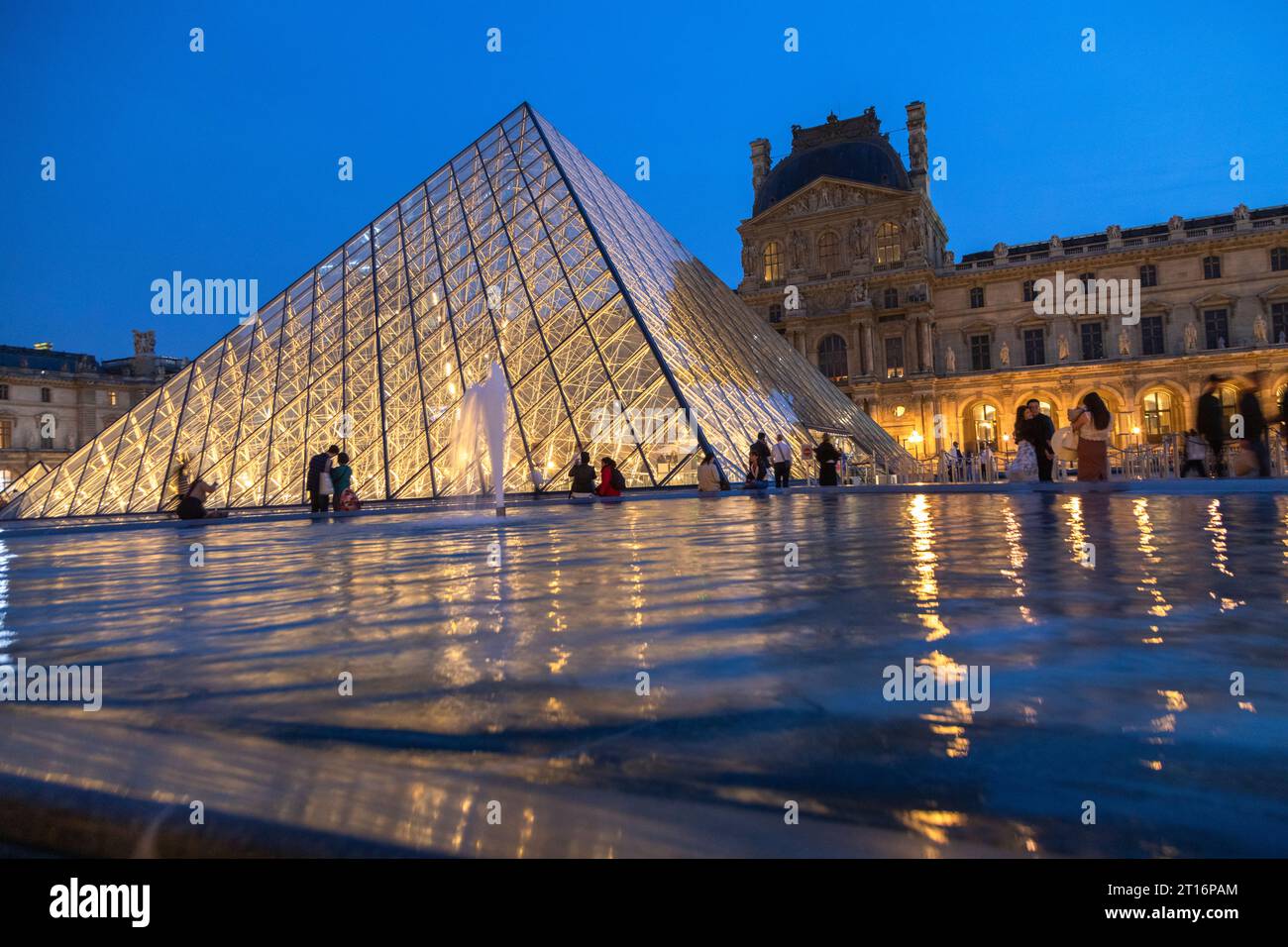 Courtyard and glass pyramid of the Louvre Museum at dusk, Paris, France ...