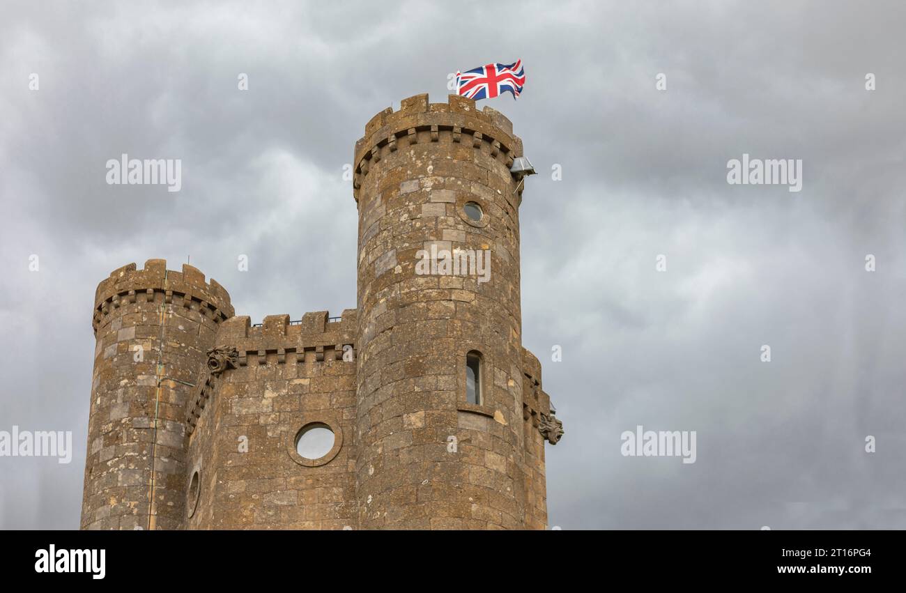 Looking upwards at a castle with circular windows against a grey sky ...