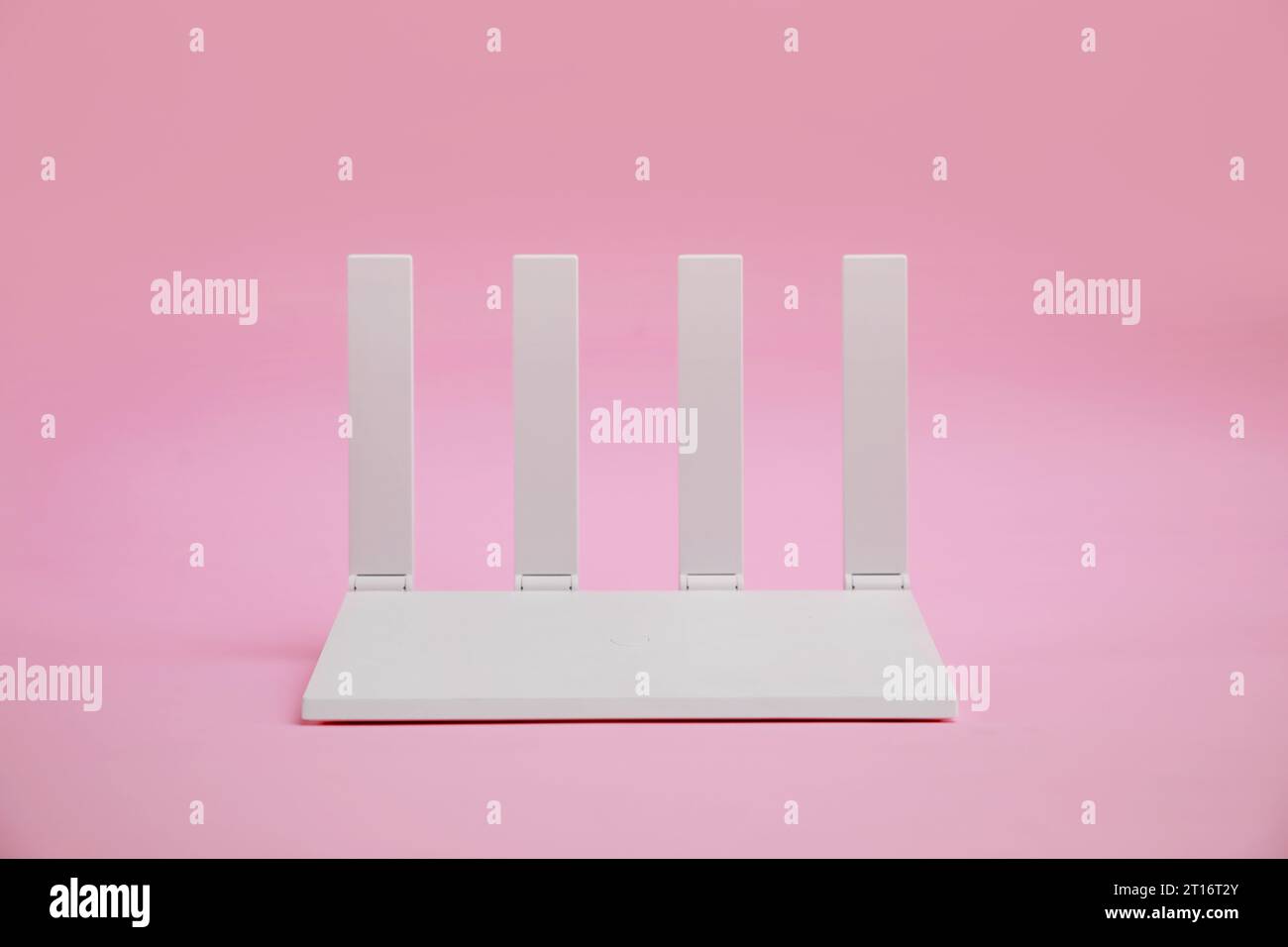 One modern Wi-Fi router on pink background Stock Photo - Alamy