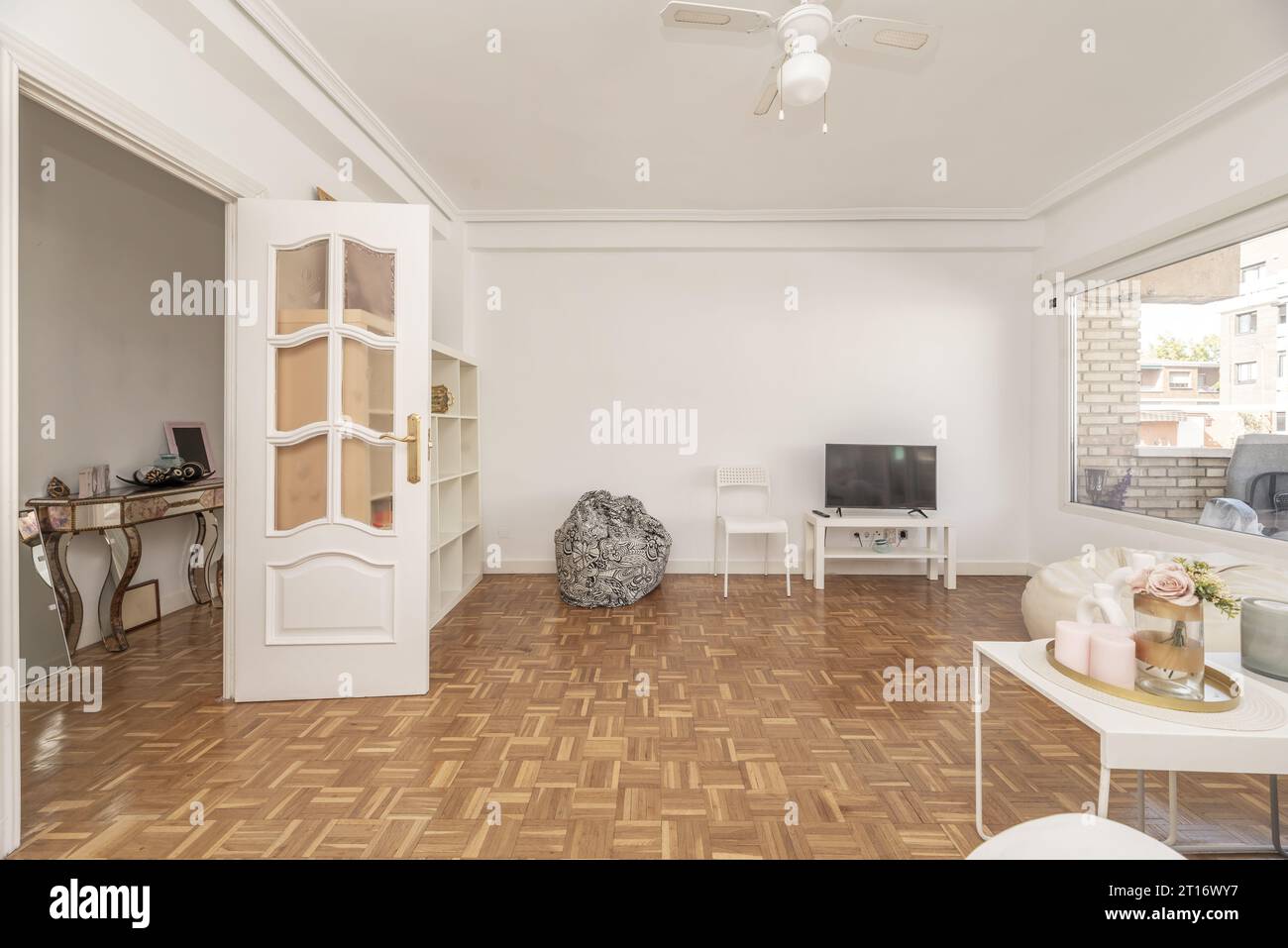 Large living room of an apartment with a few white furniture, white ...