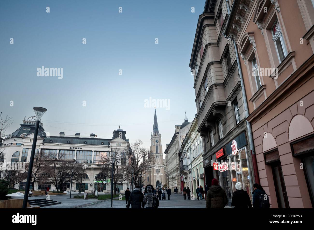 Picture of the Novi Sad cathedral with pedestrians passing by. The Name ...