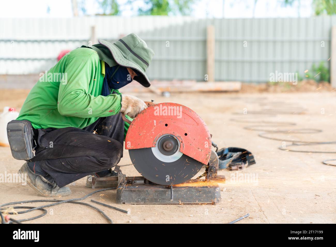 Worker cut steel rod with electric fiber cutting sparks fire iin ...