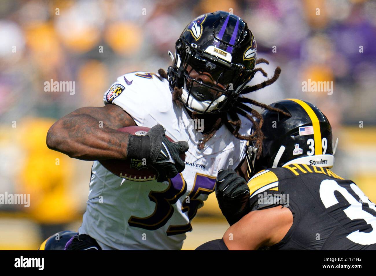 Baltimore Ravens running back Gus Edwards (35) is tackled by Pittsburgh ...