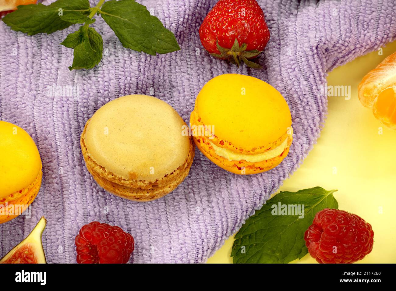 Table filled with array of macaroons and fruits visual appeal of the ...