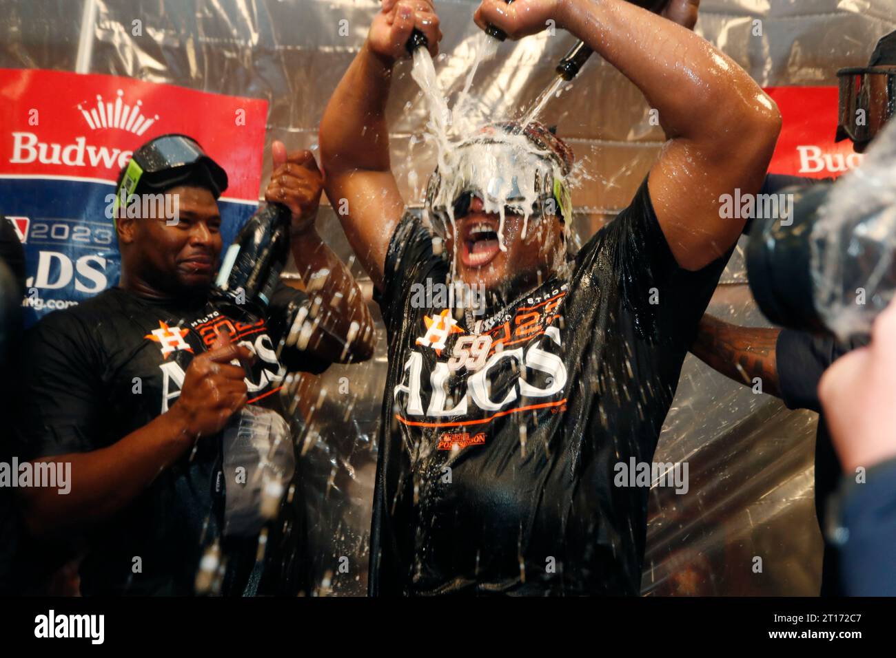The Houston Astros celebrate in the locker room after the team defeated ...