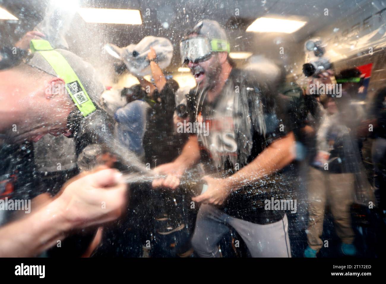 The Houston Astros celebrate in the locker room after the team defeated ...