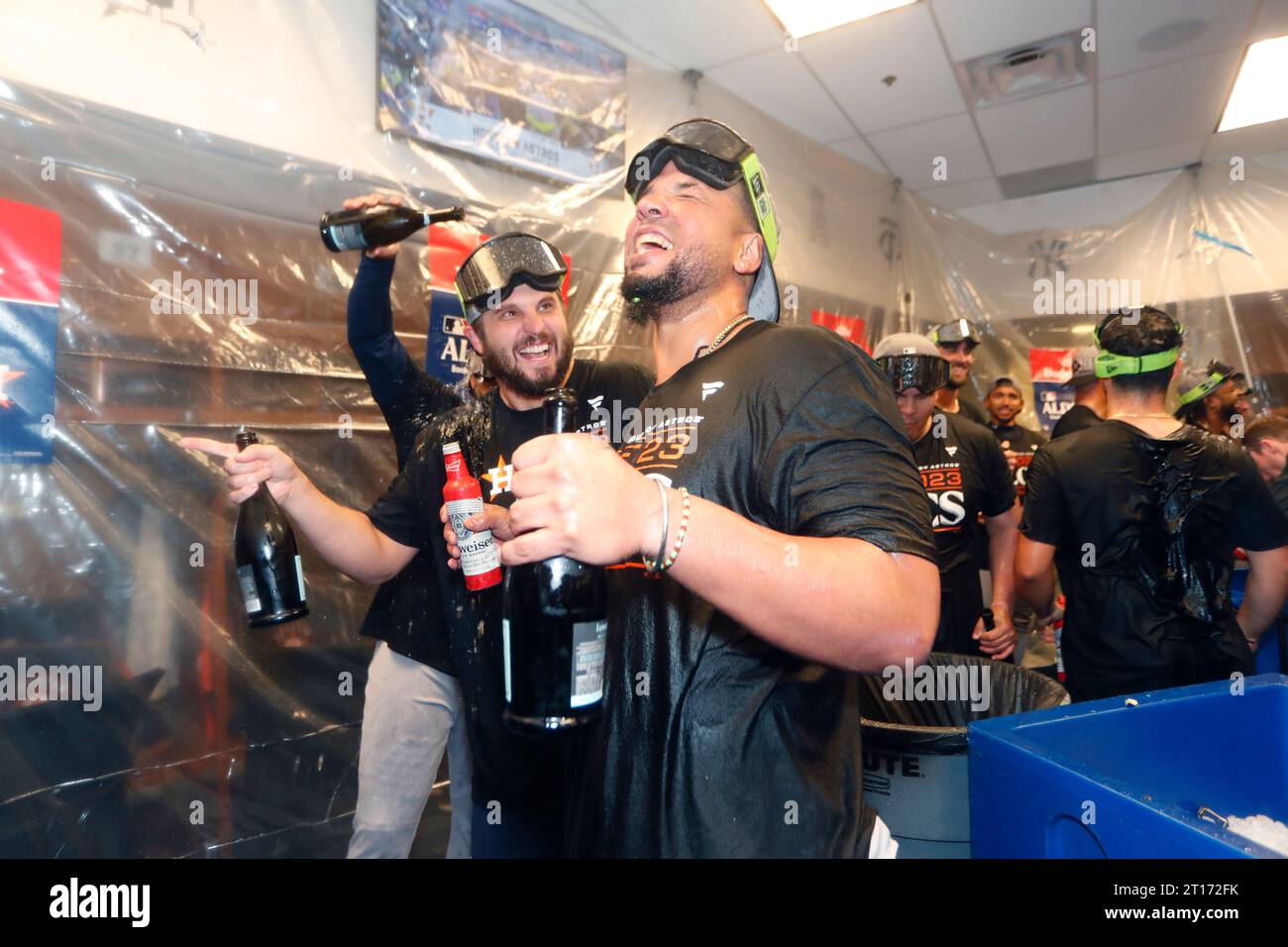 The Houston Astros celebrate in the locker room after the team defeated ...