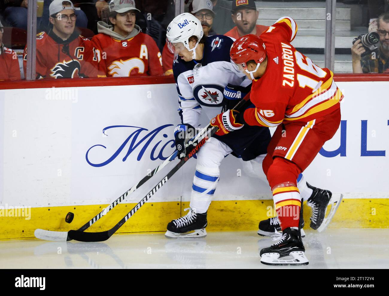 Winnipeg Jets forward Mason Appleton, left, is checked by Calgary ...