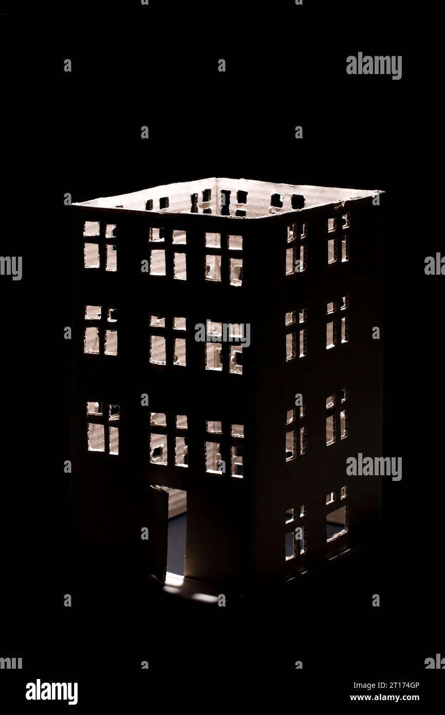 A cardboard cut-out house with windows on a black background Stock ...