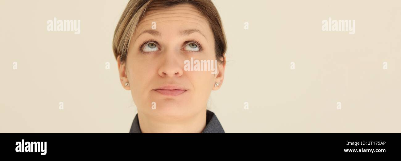Blonde woman looks up making disappointed facial expression Stock Photo ...