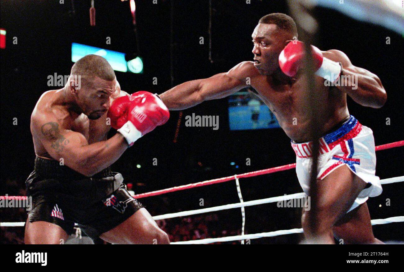 FILE - WBC heavyweight champion Mike Tyson, left, and WBA heavyweight ...