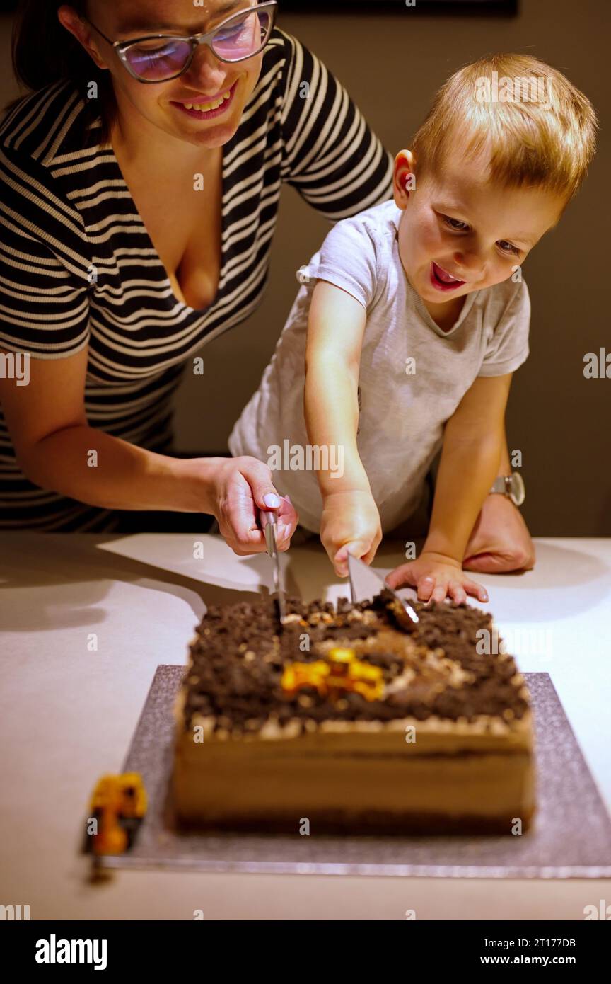 Mother and son cutting birthday cake Stock Photo - Alamy