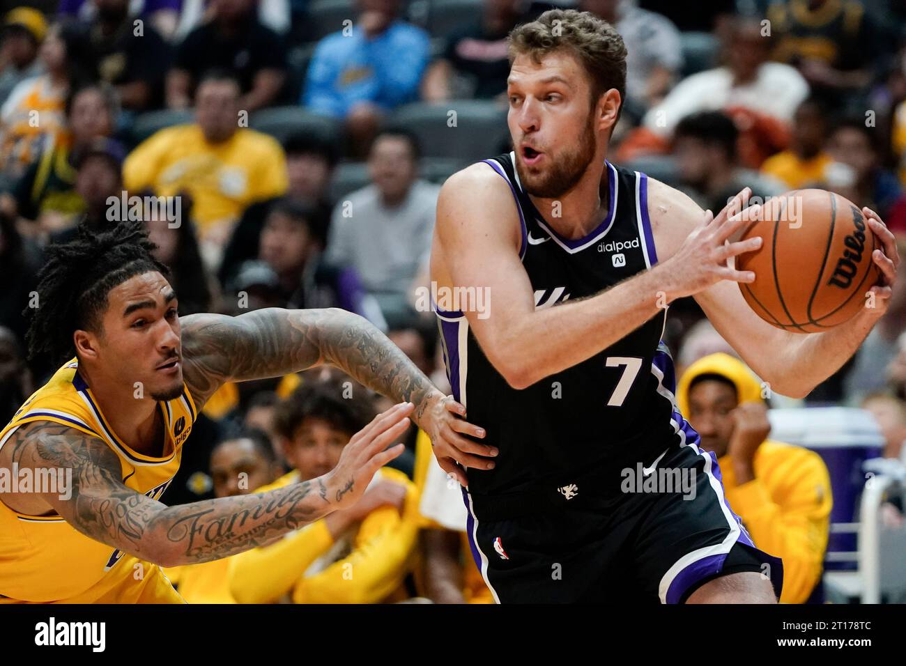 Sacramento Kings forward Sasha Vezenkov, right, drives past Los Angeles Lakers guard Jalen Hood ...