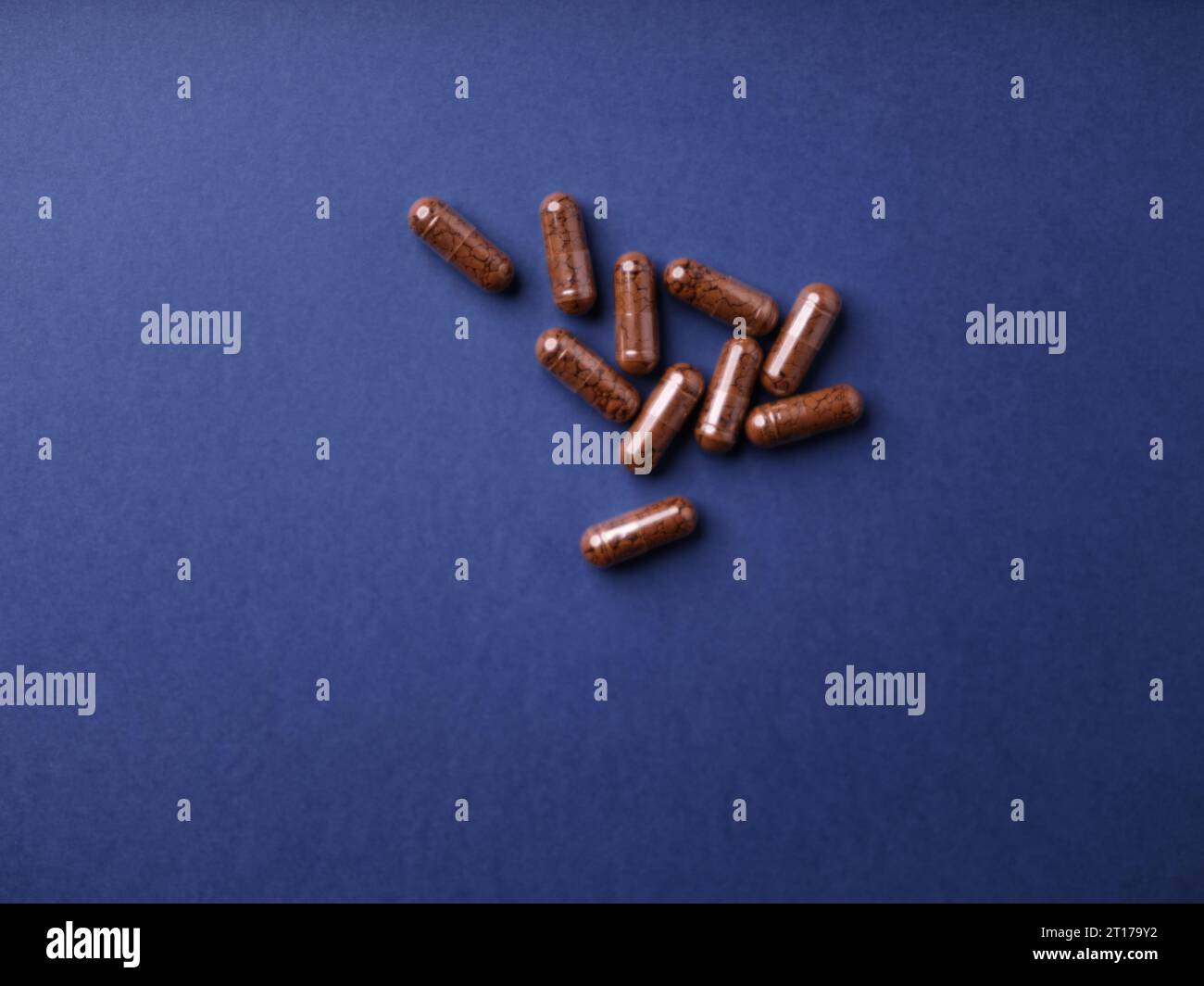 Ashwagandha (Withania somnifera) capsules. Paper background. Soft focus ...