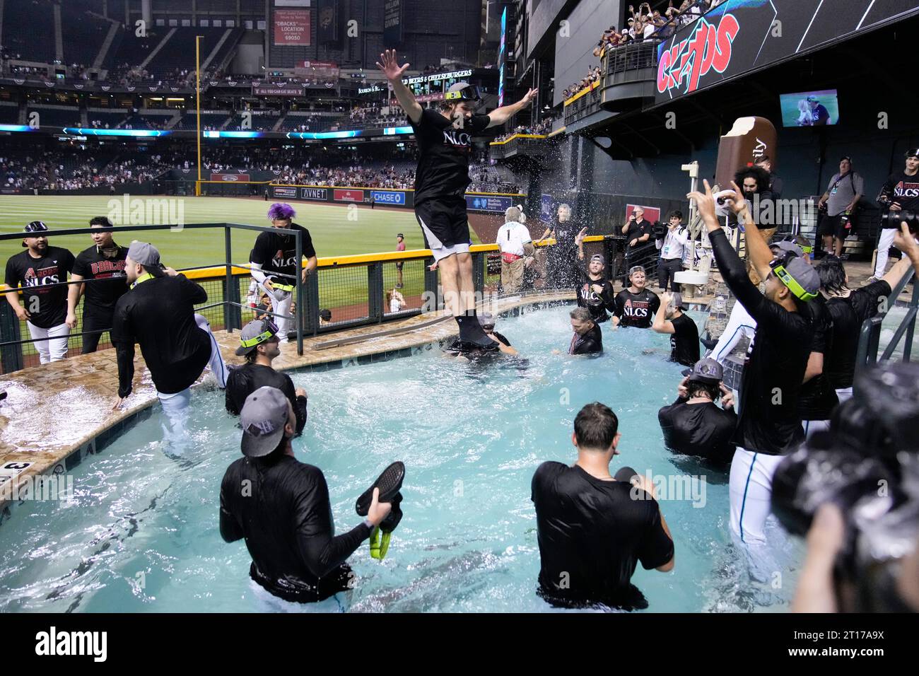 Arizona Diamondbacks pitcher Zac Gallen falls into the pool after the ...