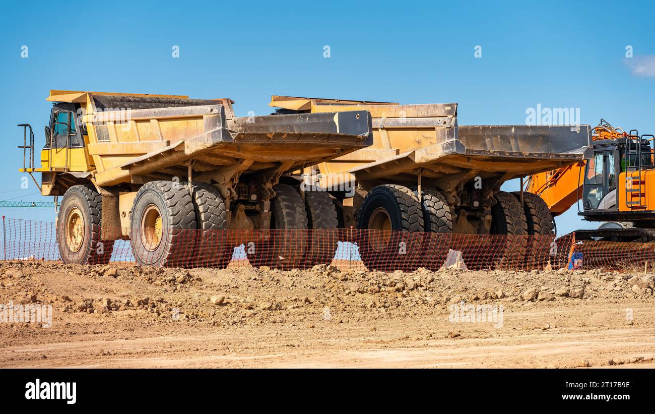 Large earth transport trucks for construction sites Stock Photo - Alamy