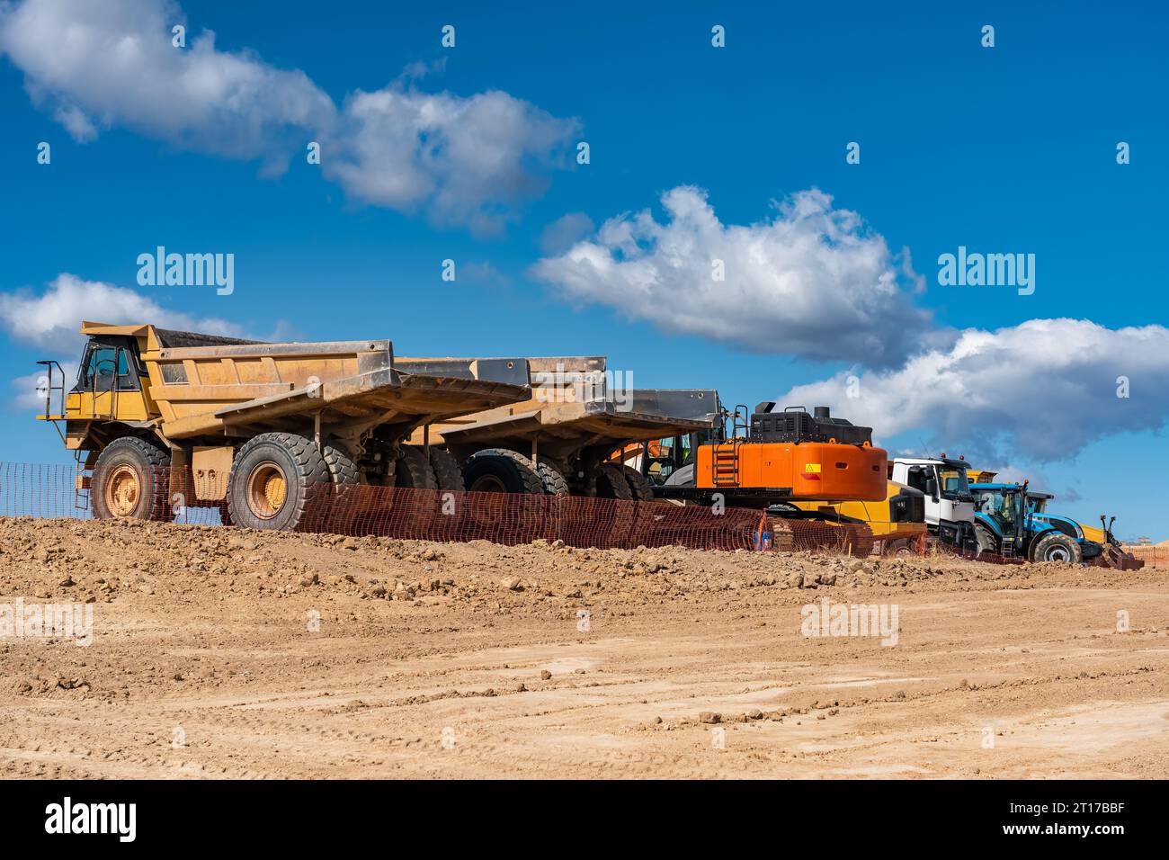Large earth transport trucks for construction sites Stock Photo - Alamy