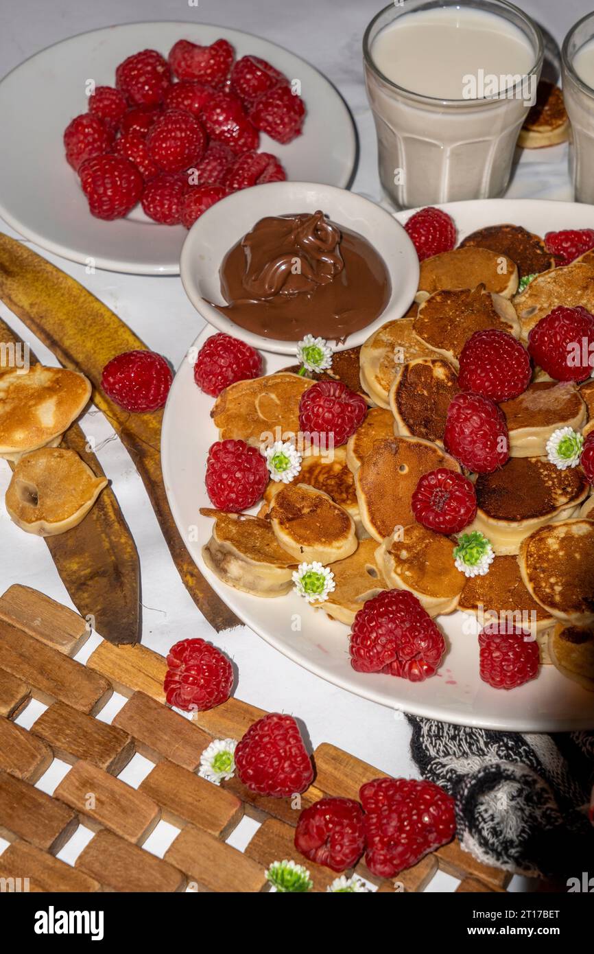 Mini pancakes served with, honey, chocolate, peanut butter and milk ...