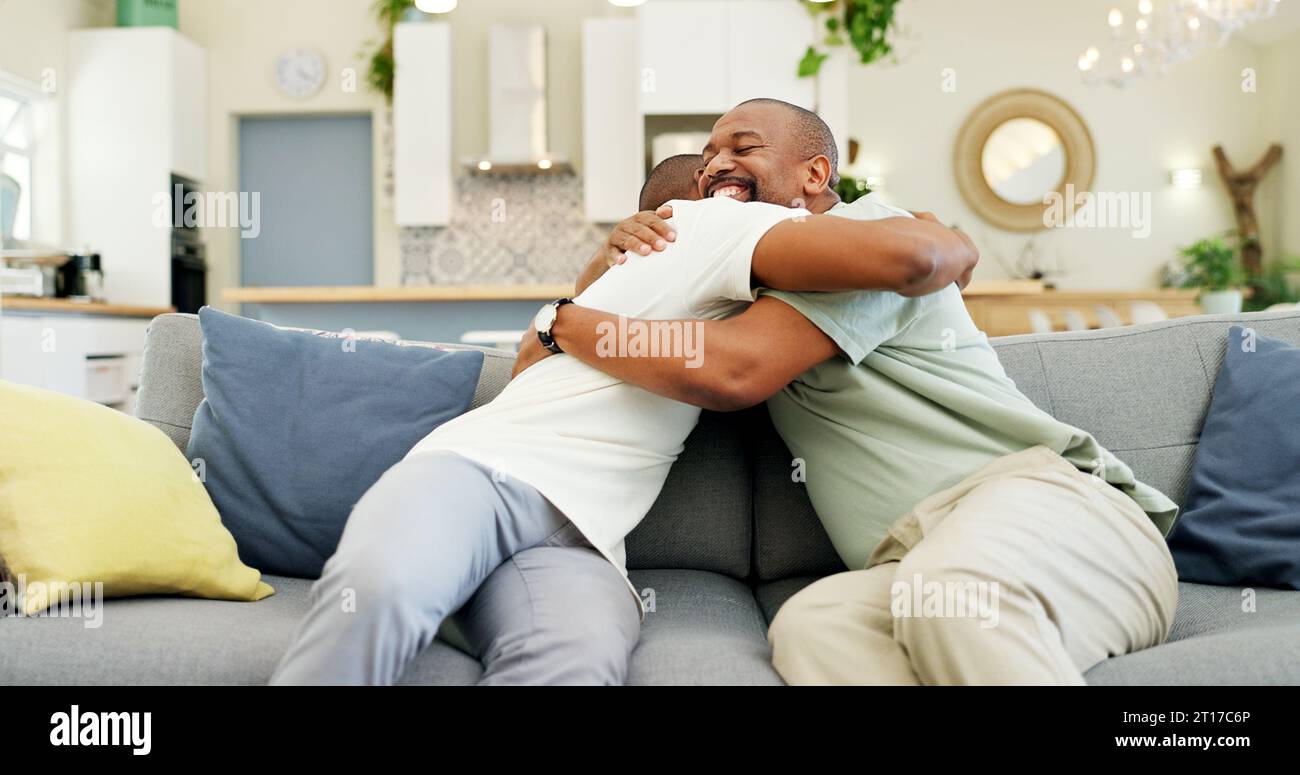 Hug, talking and a father and son on the sofa for a visit, bonding or ...