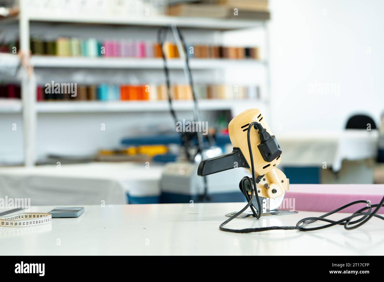Electric cutting fabric machine on workbench in sewing factory Stock ...