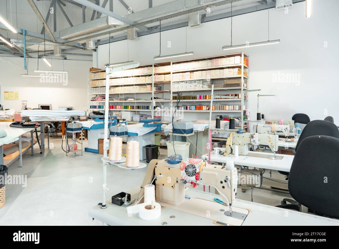 Interior of a sewing warehouse of furniture factory with equipment and ...