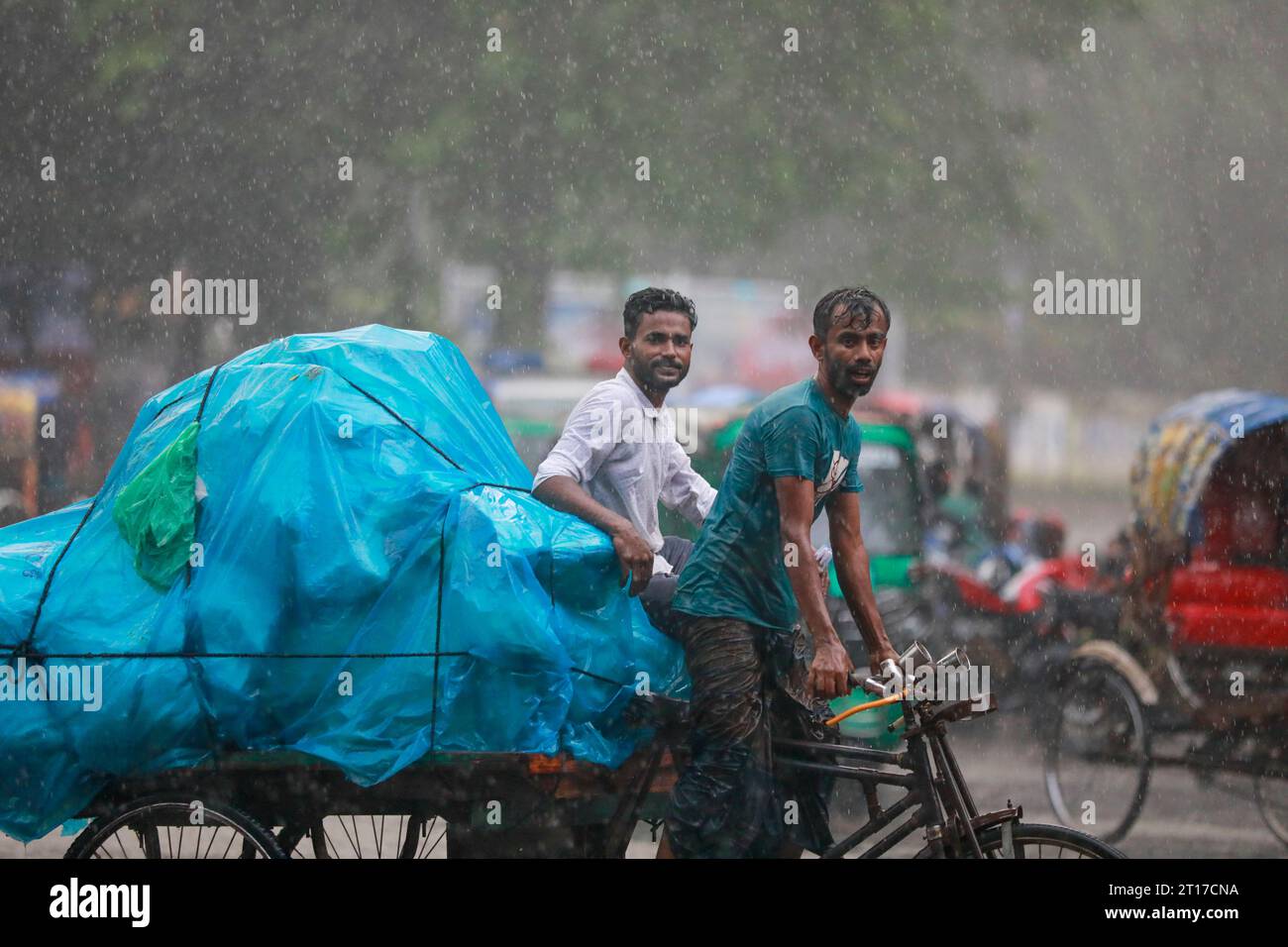 Dhaka, Bangladesh. 11th Oct, 2023. A rickshaw van puller rides a ...