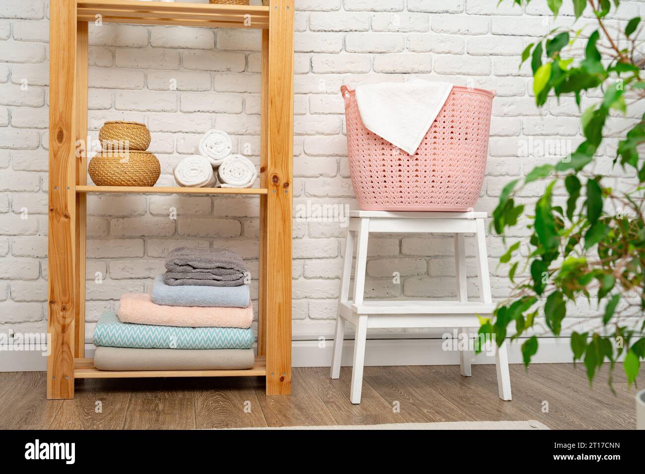 Pink plastic laundry basket in a bathroom Stock Photo - Alamy