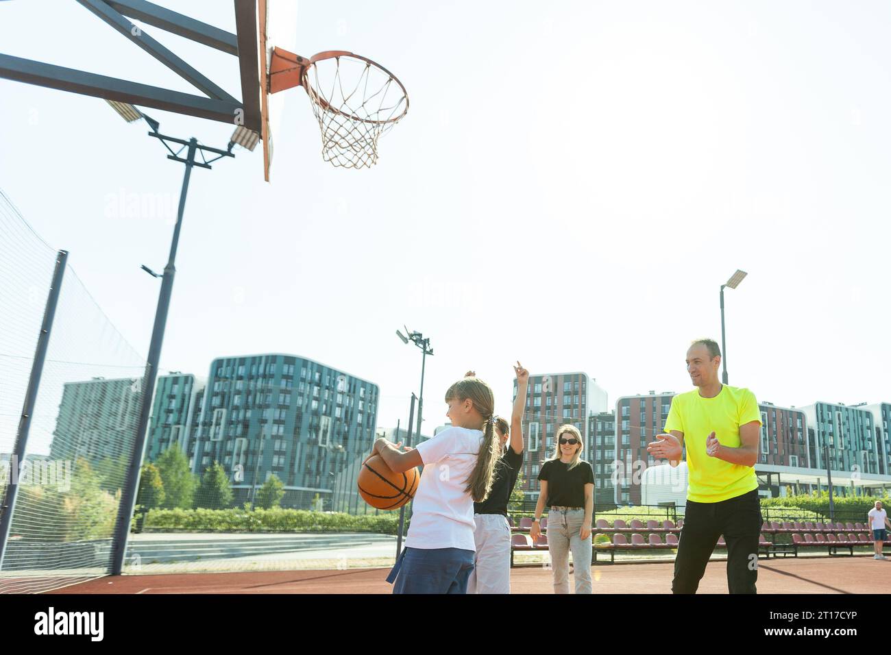 family playing basketball on court Stock Photo - Alamy
