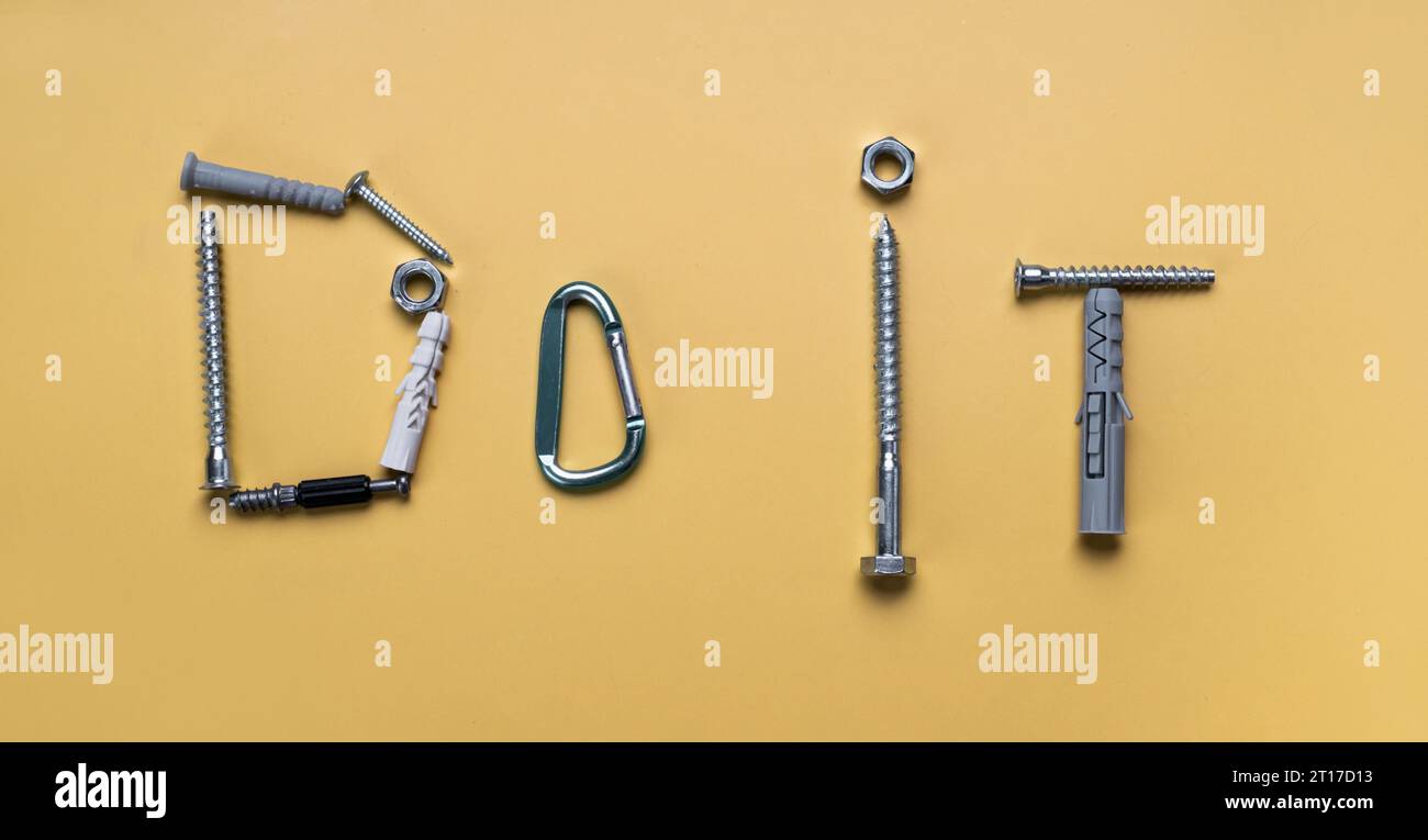 Sign Do it, frame with copy space made of bolts, screws. Banner on ...