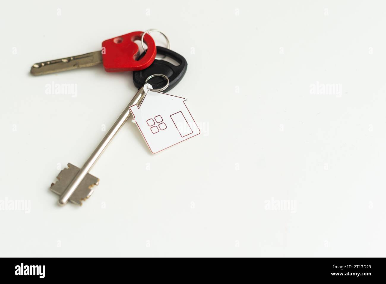 key chain with house symbol and keys on white background, Real estate ...