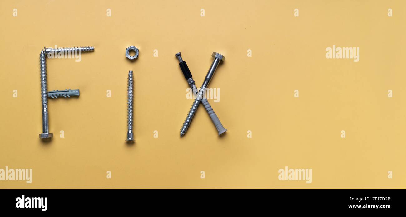 Sign Fix, frame with copy space made of bolts, screws. Banner on yellow ...