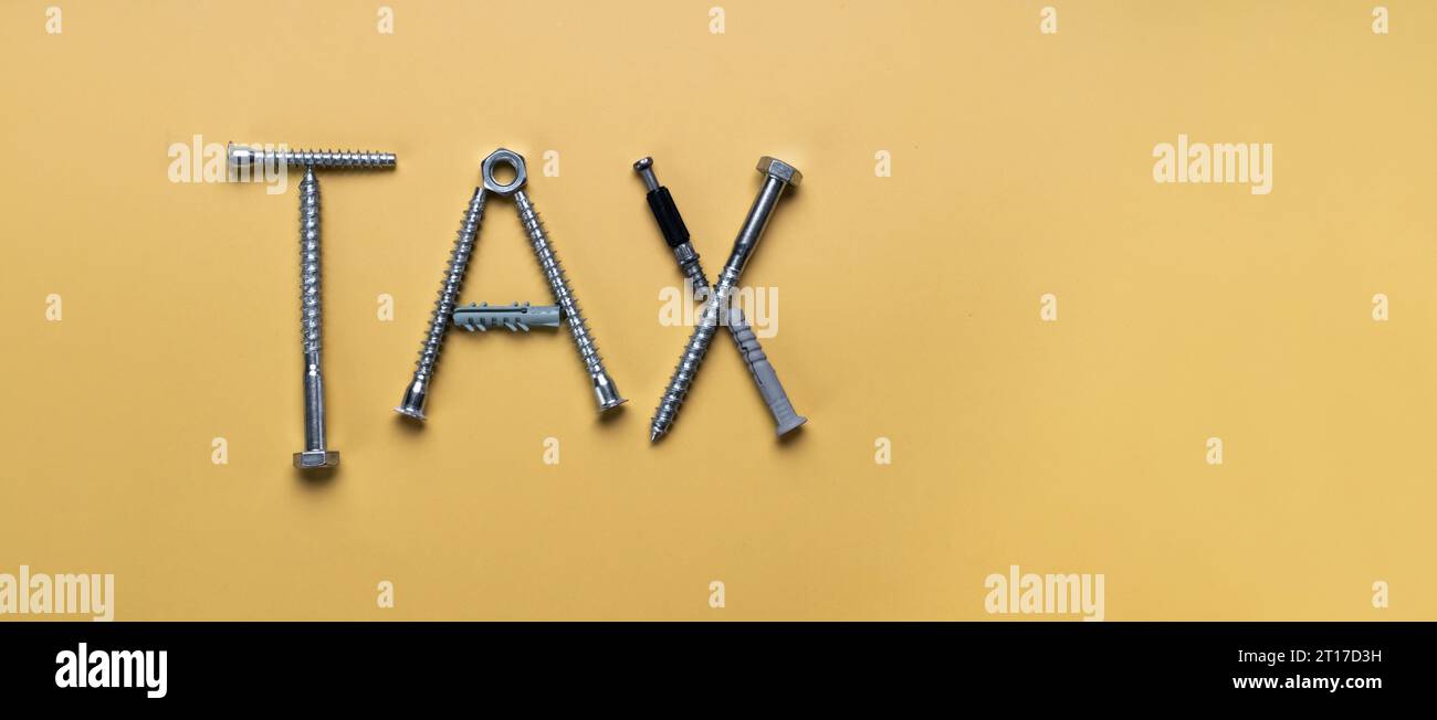 Sign Tax, frame with copy space made of bolts, screws. Banner on yellow ...