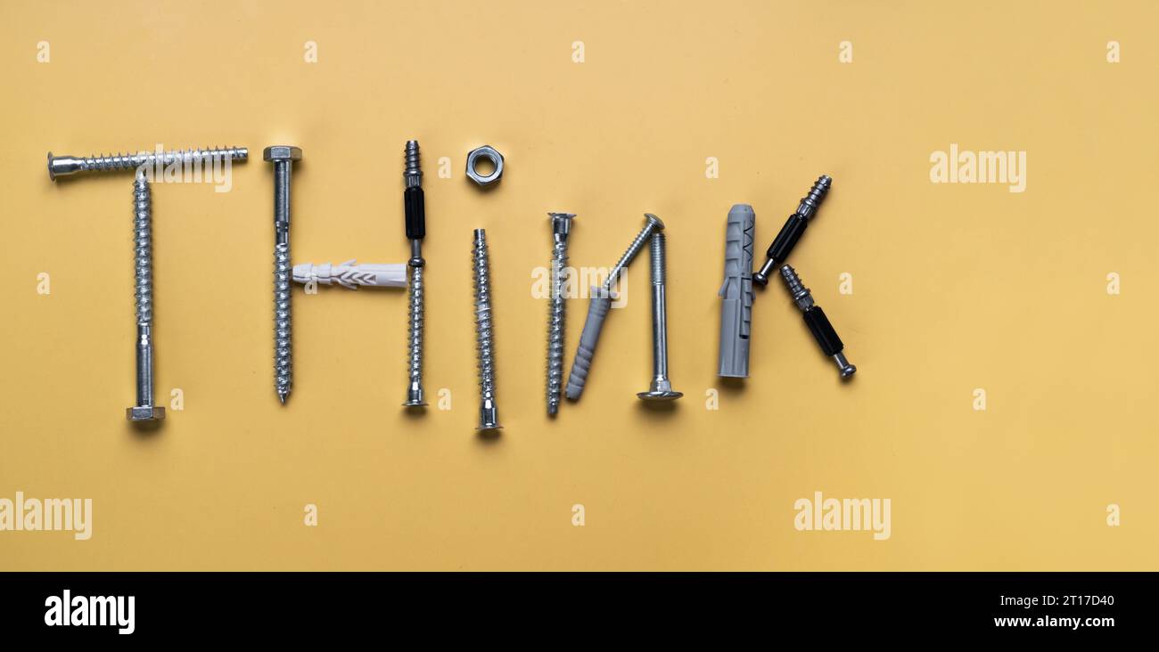 Sign Think, frame with copy space made of bolts, screws. Banner on ...