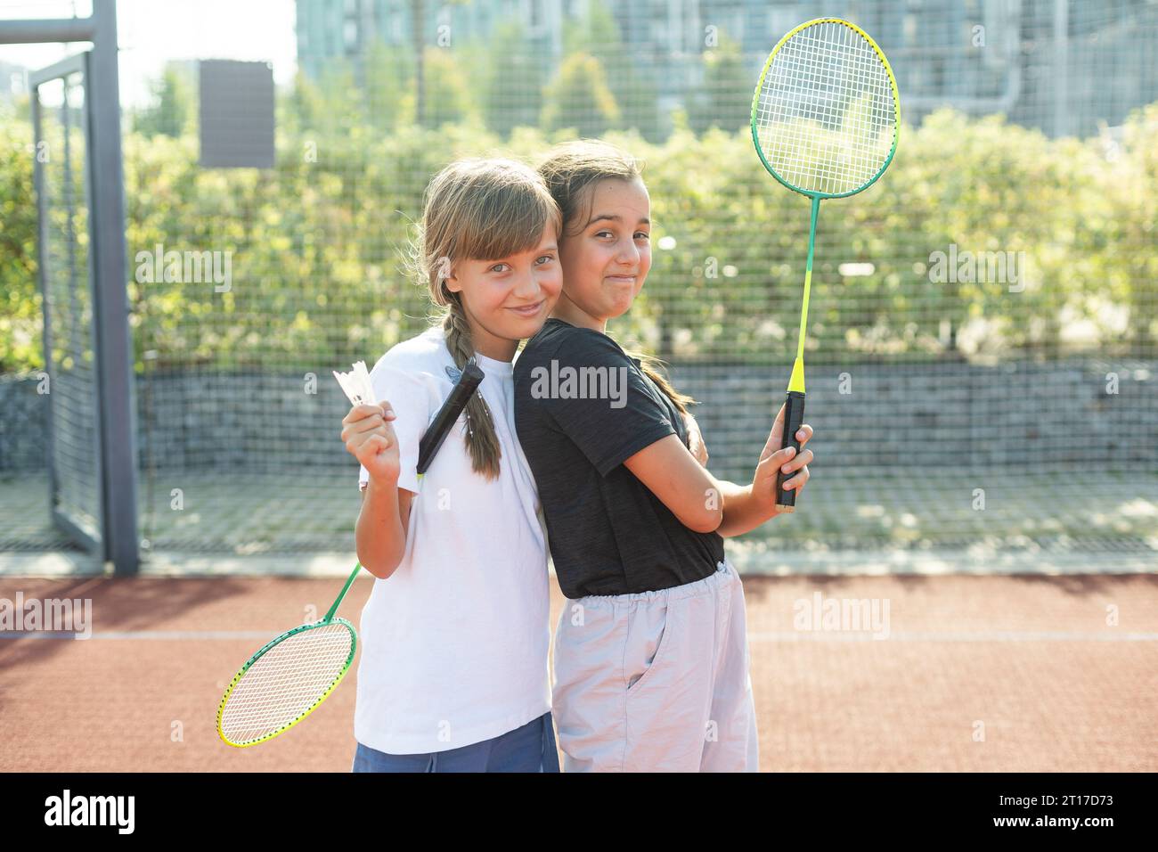 Happy sporty elementary school age girl, child playing badminton ...