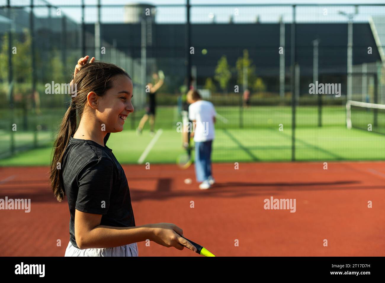 Two girls with badminton rackets on the football field Stock Photo - Alamy