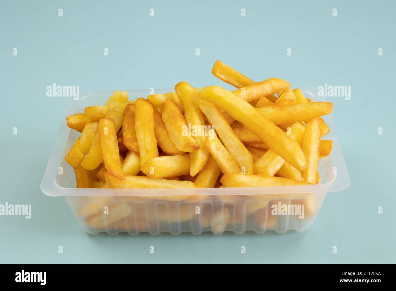 fries in a tray on a blue background Stock Photo - Alamy