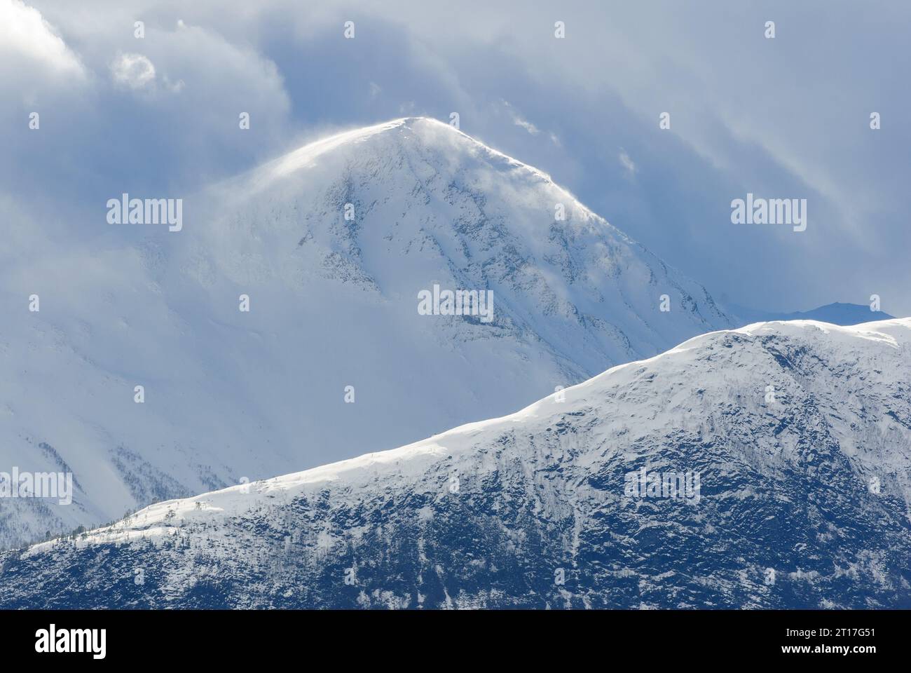 snowy mountain peak between clouds Stock Photo - Alamy