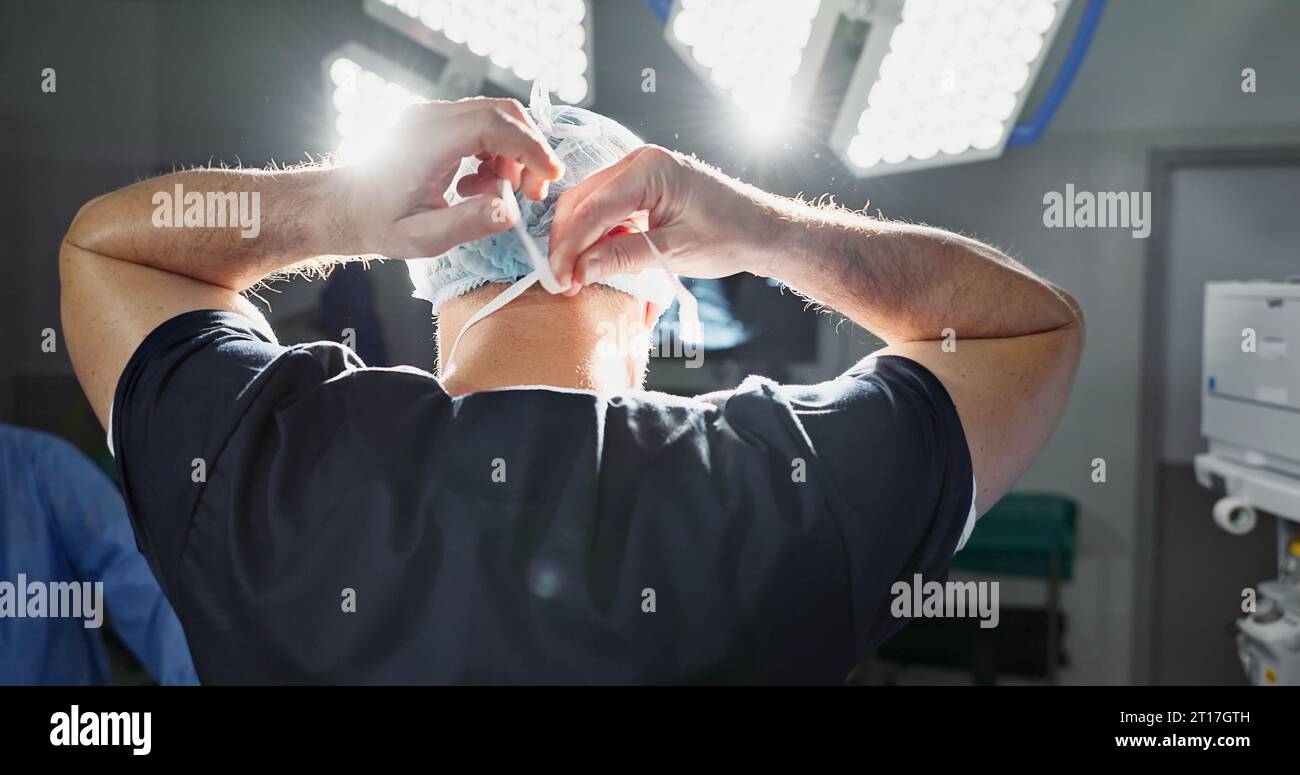 Surgery, preparation and doctor tie mask in operating room for medical ...