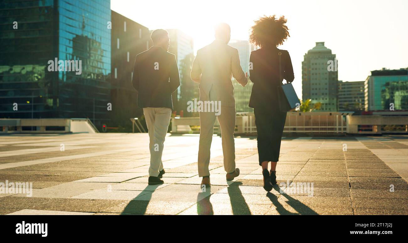 Back, business team and walking outdoor in city for morning travel to ...