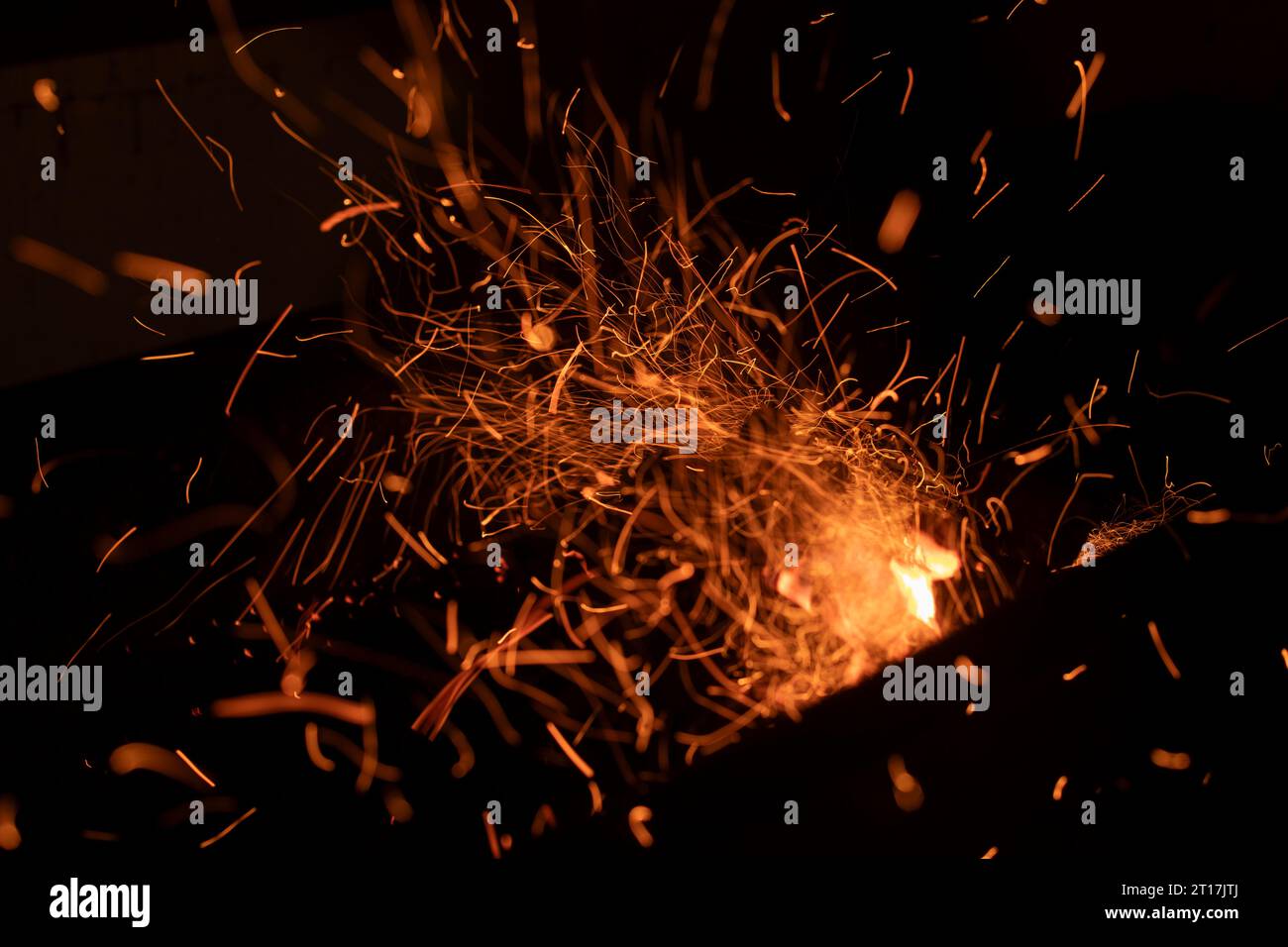 Sparks from Fire. Sparks on a black background. The combustion process ...