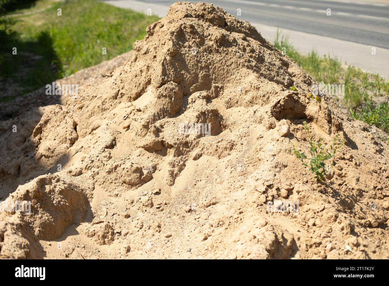 Mountain of sand for road. Yellow sand in yard. Pile of construction ...