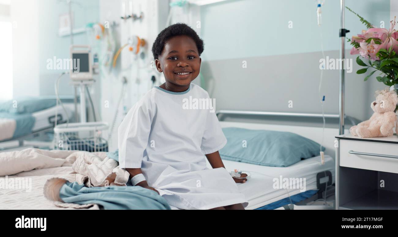 Sick African boy child, hospital and bed with face, smile and rest for ...