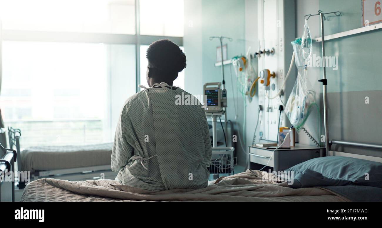 Patient, hospital and sitting on bed with sad, depression and worry for ...