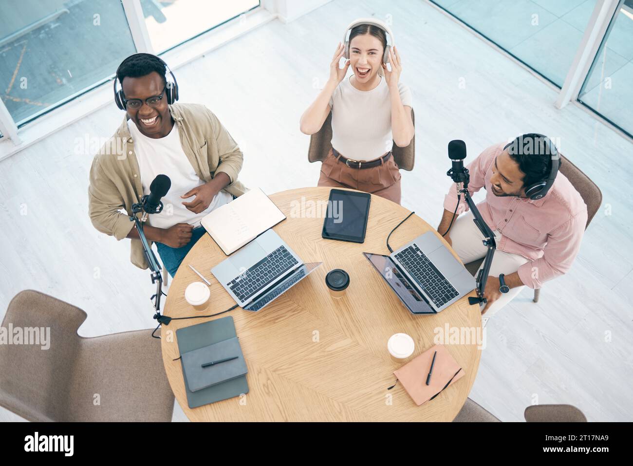 Radio, podcast or broadcast with a content creator team in their office ...